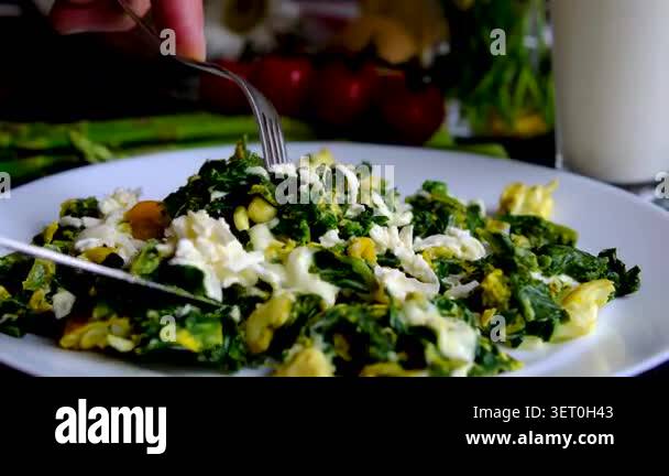 Fresh spinach is cooked with eggs and creamy cheese in a skillet, then ...