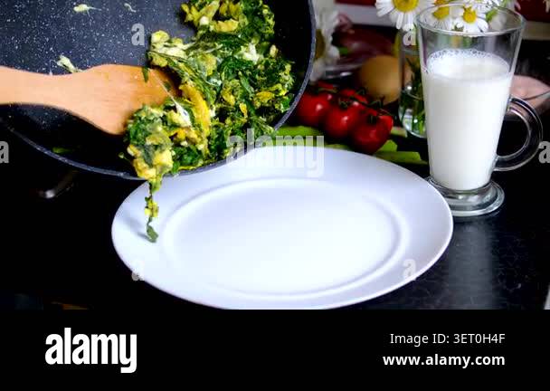Fresh spinach is cooked with eggs and creamy cheese in a skillet, then ...