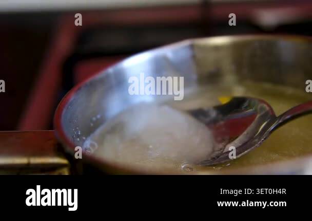 Woman prepares a light cottage cheese dessert with cocoa, milk, gelatin ...