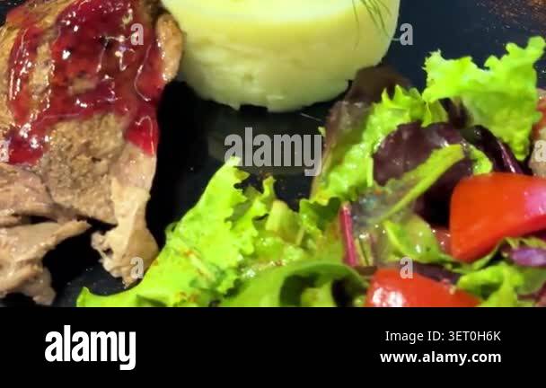 Crispy duck leg served with cranberry sauce, creamy mashed potatoes and ...
