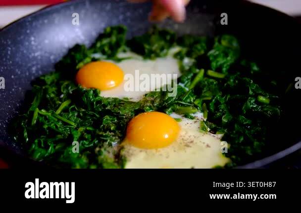 Fresh spinach is cooked with eggs and creamy cheese in a skillet, then ...