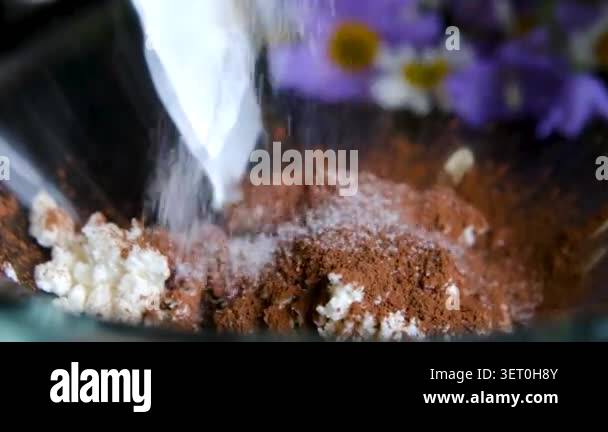 Woman prepares a light cottage cheese dessert with cocoa, milk, gelatin ...