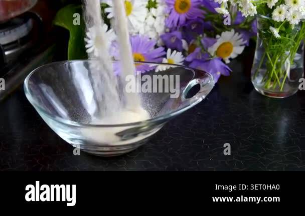 Woman prepares a light cottage cheese dessert with cocoa, milk, gelatin ...