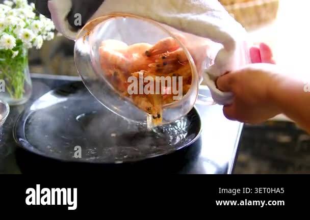 Shrimp are added to boiling water, seasoned with salt and cooked until ...