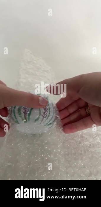 Packing handmade lavender candle in bubble wrap, small business order ...