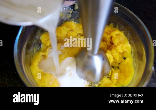 Woman prepares a light cottage cheese dessert with cocoa, milk, gelatin ...