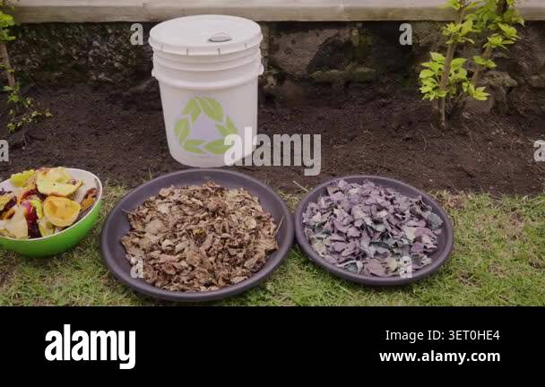 Panning shot of organic materials for home composting in an outdoor ...