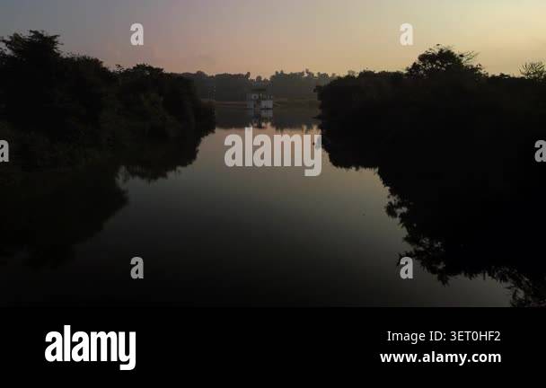 Aerial drone skims just above the surface of Chairel Lagoon at dawn in ...