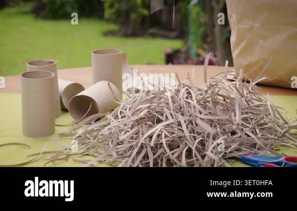 Paper shavings falling onto a garden table for composting Stock Video ...