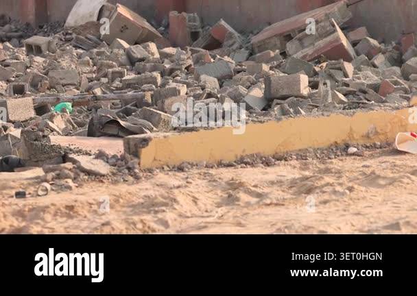 Ruins of destroyed brick and concrete house after demolition or war ...