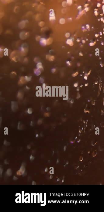 Cinematic rainy city atmosphere seen through wet glass surface. High ...