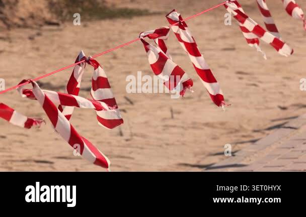 Red and white plastic safety tape marking construction area boundary ...