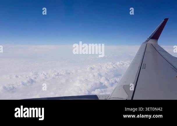 View from a passenger aircraft window showing the wing extending above ...