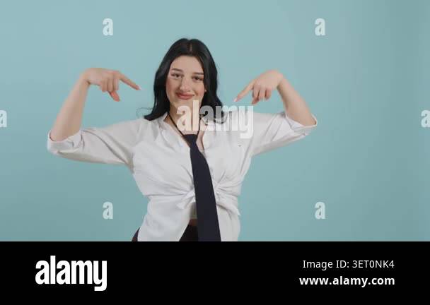 A proud female person gestures towards herself while standing against a ...
