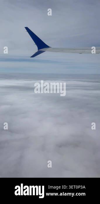 airplane wing above clouds from passenger window Stock Video Footage ...