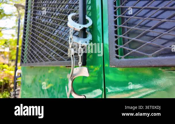 Police Handcuffs Hanging on Green Prisoner Transport Van Window Stock ...