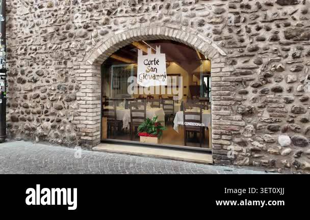 Bardolino, Italy - May 14, 2026 - Charming Italian cafe exterior with ...