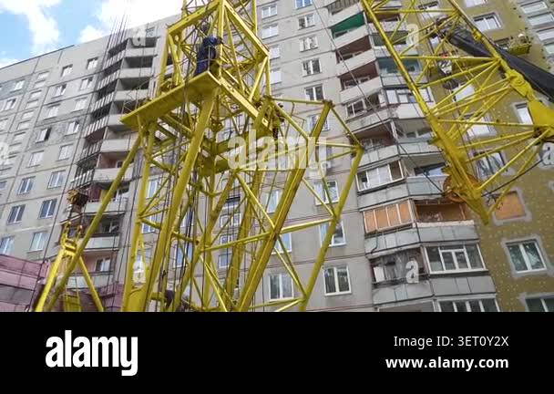 Construction crane near a residential high-rise building during ...