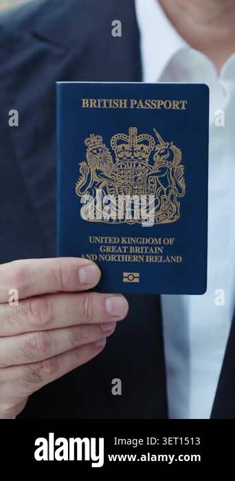 Closeup view of businessman hand holds British passport outdoor ...