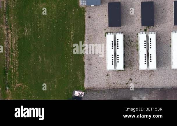 Aerial drone view of a BESS facility storing solar and wind power ...