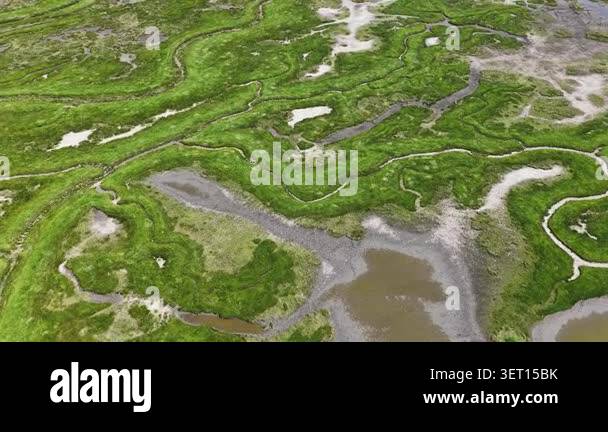 High altitude aerial view slowly tilting up from the intricate patterns ...