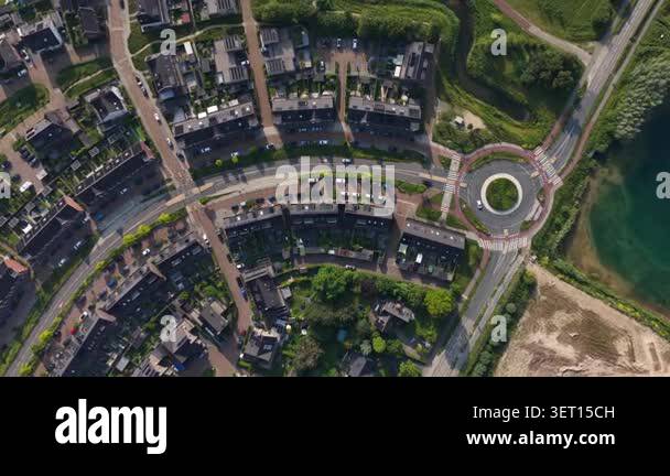 Top down aerial view shows a modern suburban neighborhood with curved ...