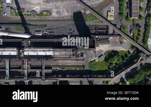 Aerial top down perspective of a large, old steel manufacturing plant ...