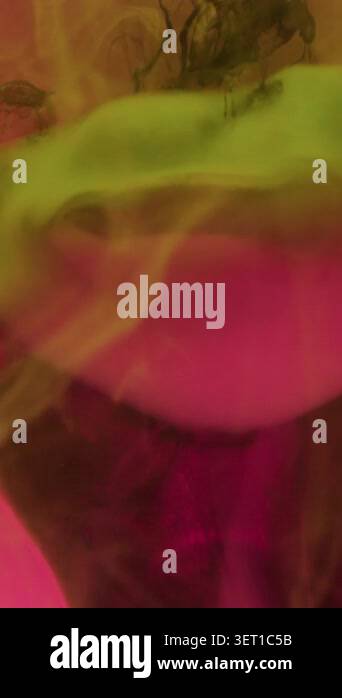 Vertical video. Color steam. Explode lamp. Defocused pink yellow brown ...