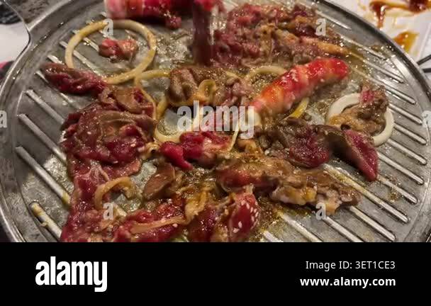 Close up footage of cooking sliced beef marinade with onions on a hot ...