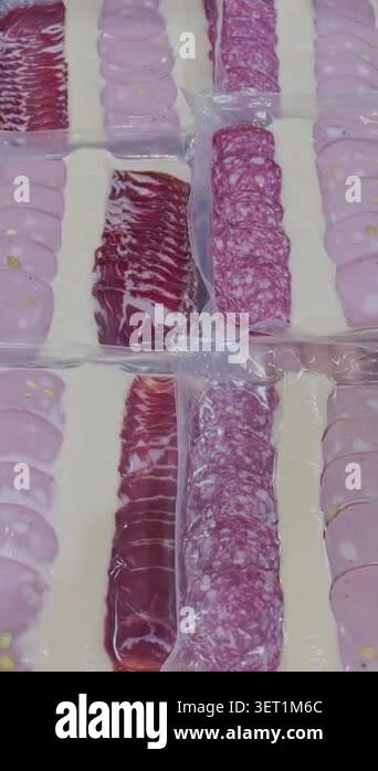 Packaged cheese, salami, pistachio mortadella, and cured pork ...