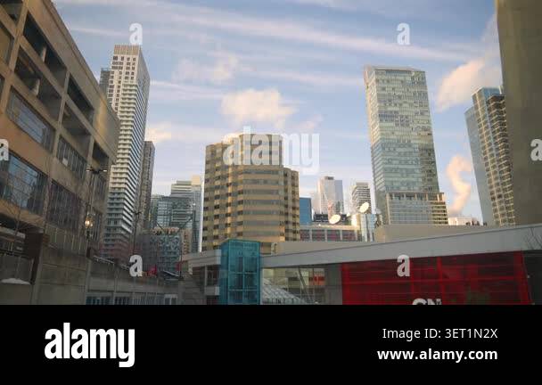 Urban skyline surrounding the CN Tower base view from street level ...
