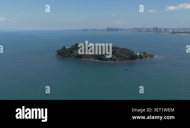 Aerial turning view: the lush, forested island from behind, with the ...