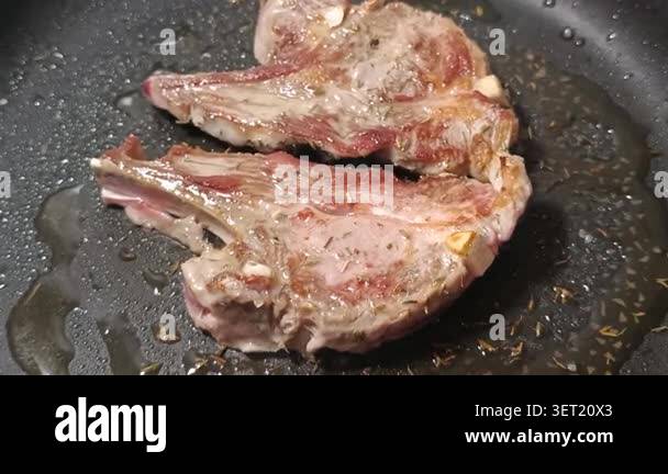 lamb chops cooking in a pan Stock Video Footage - Alamy