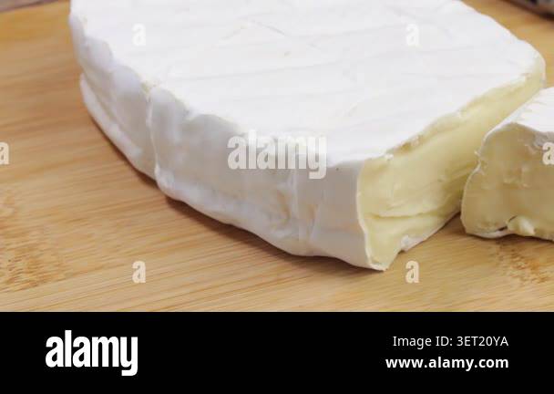 oval melting cheese on a cutting board Stock Video Footage - Alamy