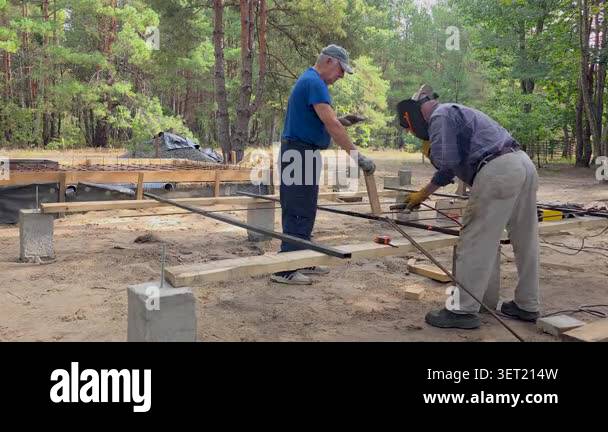 Workers Welding Steel Reinforcement Frame for Residential Foundation ...