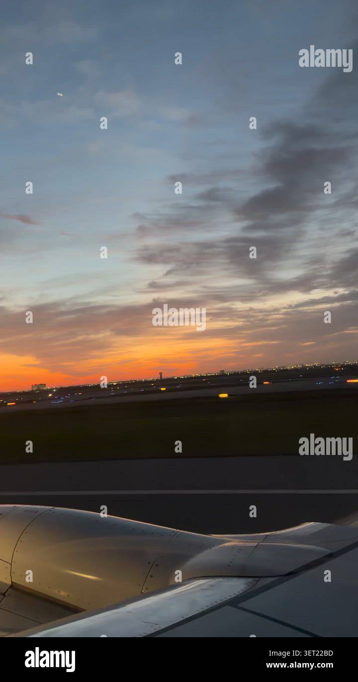 Airplane Taking Off at Sunset with Golden Sky and Airport Runway Stock ...
