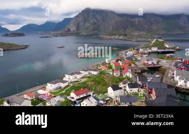 Aerial of small traditional town Henningsvaer with greenery covered ...
