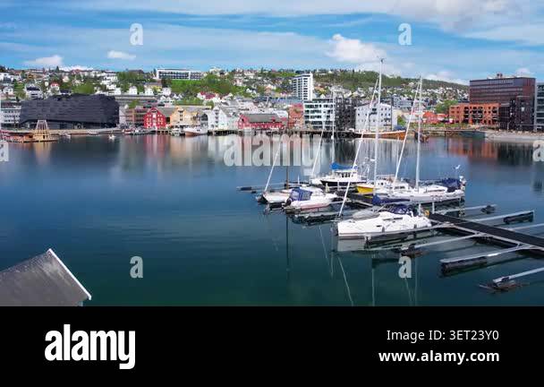 Soaring above the Norwegian city of Troms in the rays of the midnight ...