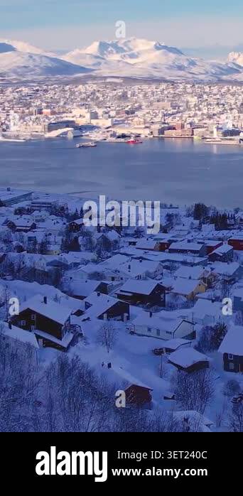 Snow covered mountain range on coastline in winter, Norway ...