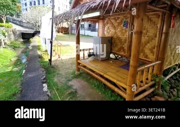 Bamboo huts for rent in tropical Thai nature with palm trees greenery ...