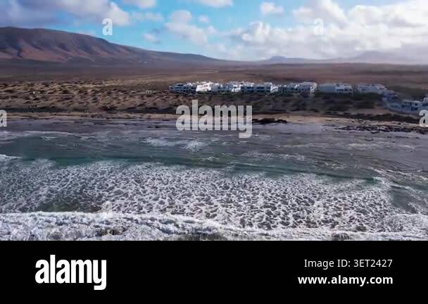 Explore the stunning aerial perspective of Famara beach in Lanzarote ...