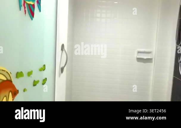 Affordable clean hotel bathroom featuring toilet sink shower mirror in ...