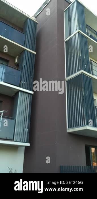 Descending shot of a contemporary residential buildings facade. The ...