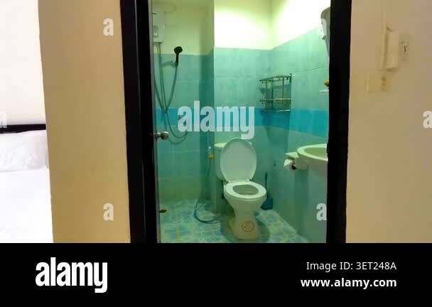 Affordable clean hotel bathroom featuring toilet sink shower mirror in ...