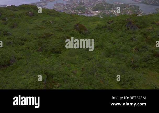 Drone footage over lush green forested mountains overlooking ...