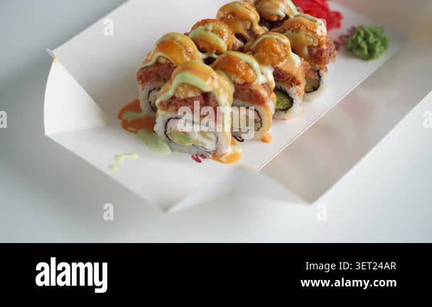 Close-up view of a freshly made Japanese sushi roll set with baked ...