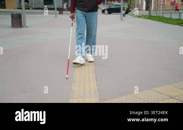 Independent african american man with a visual impairment navigating a ...