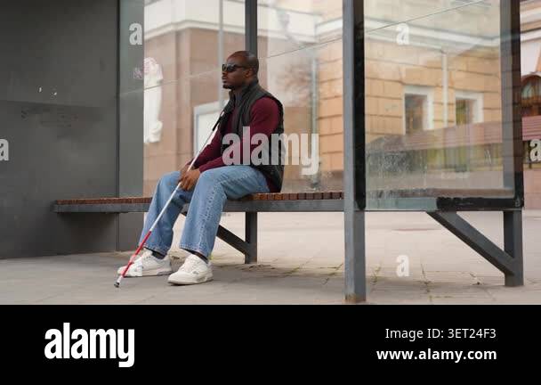 Independent african american man with a visual impairment sitting alone ...