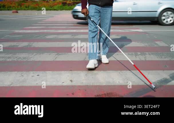 Independent african american person with a vision impairment using a ...