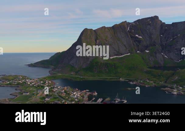 Aerial drone footage of dramatic Lofoten Islands mountains rising above ...